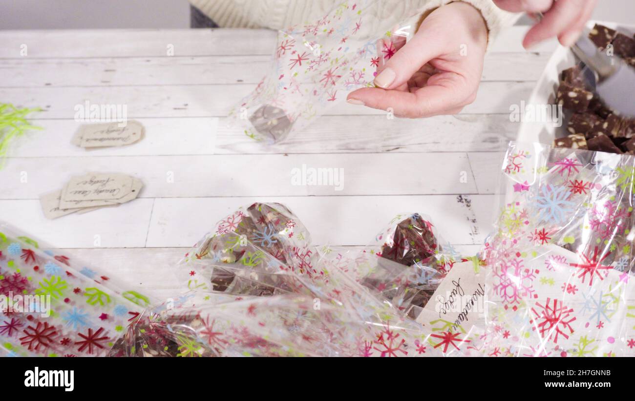Step by step. Packaging homemade macadamia fudge into small gift bags ...