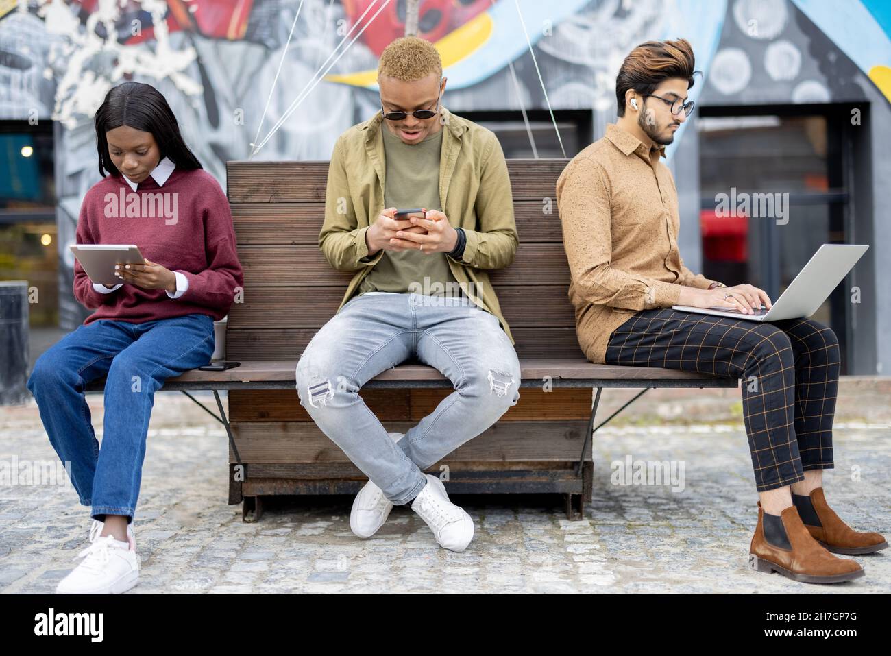 Young students using gadgets at university campus Stock Photo - Alamy