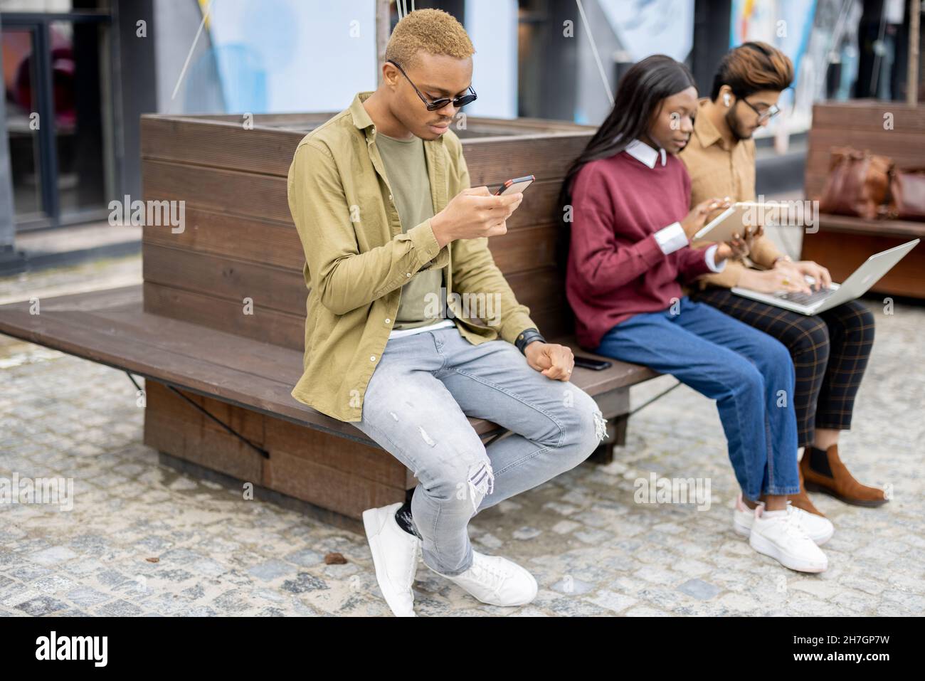 Young students using gadgets at university campus Stock Photo - Alamy