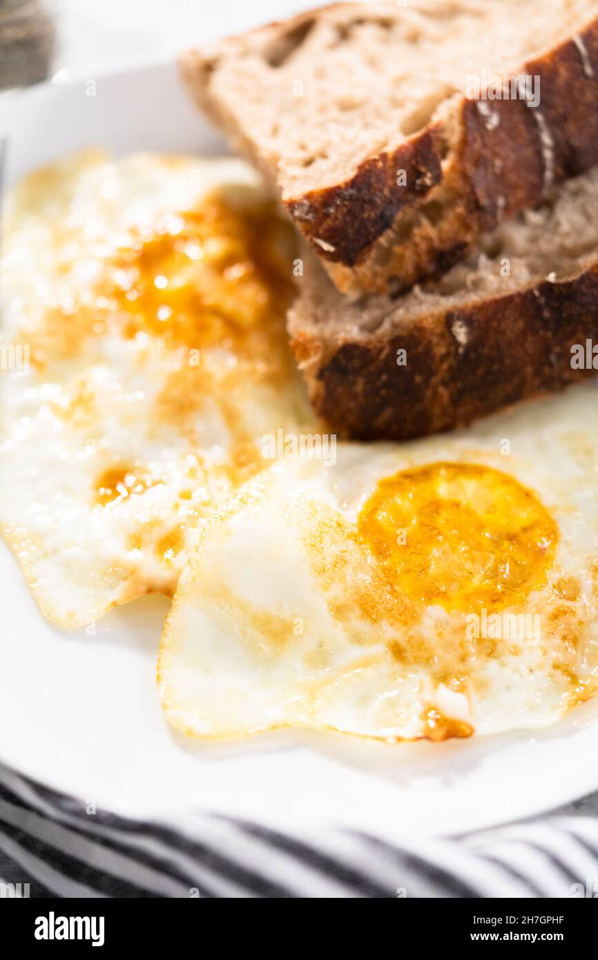 Simple breakfast with eggs over easy and sourdough wheat bread Stock ...