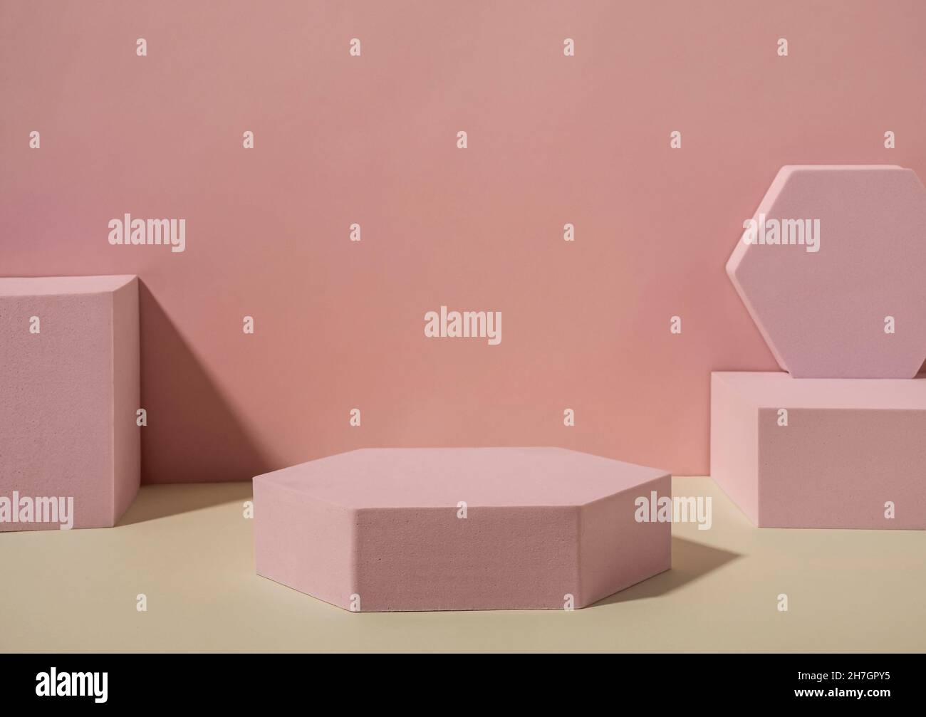 Models of pink geometrical shapes, squares and hexagons, placed on ...