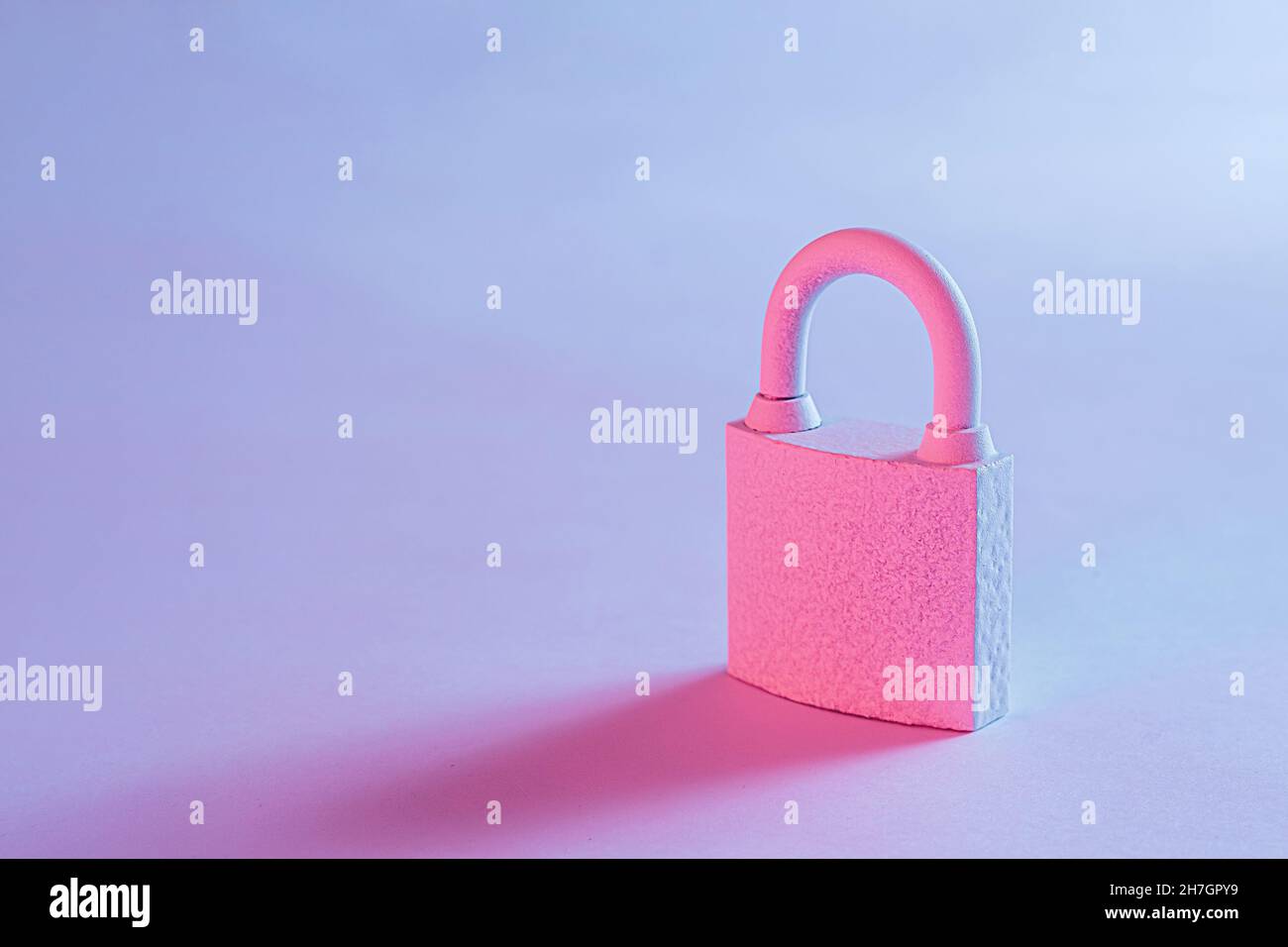 Close-up of a rusty white lockpad with shadow on studio blue background ...
