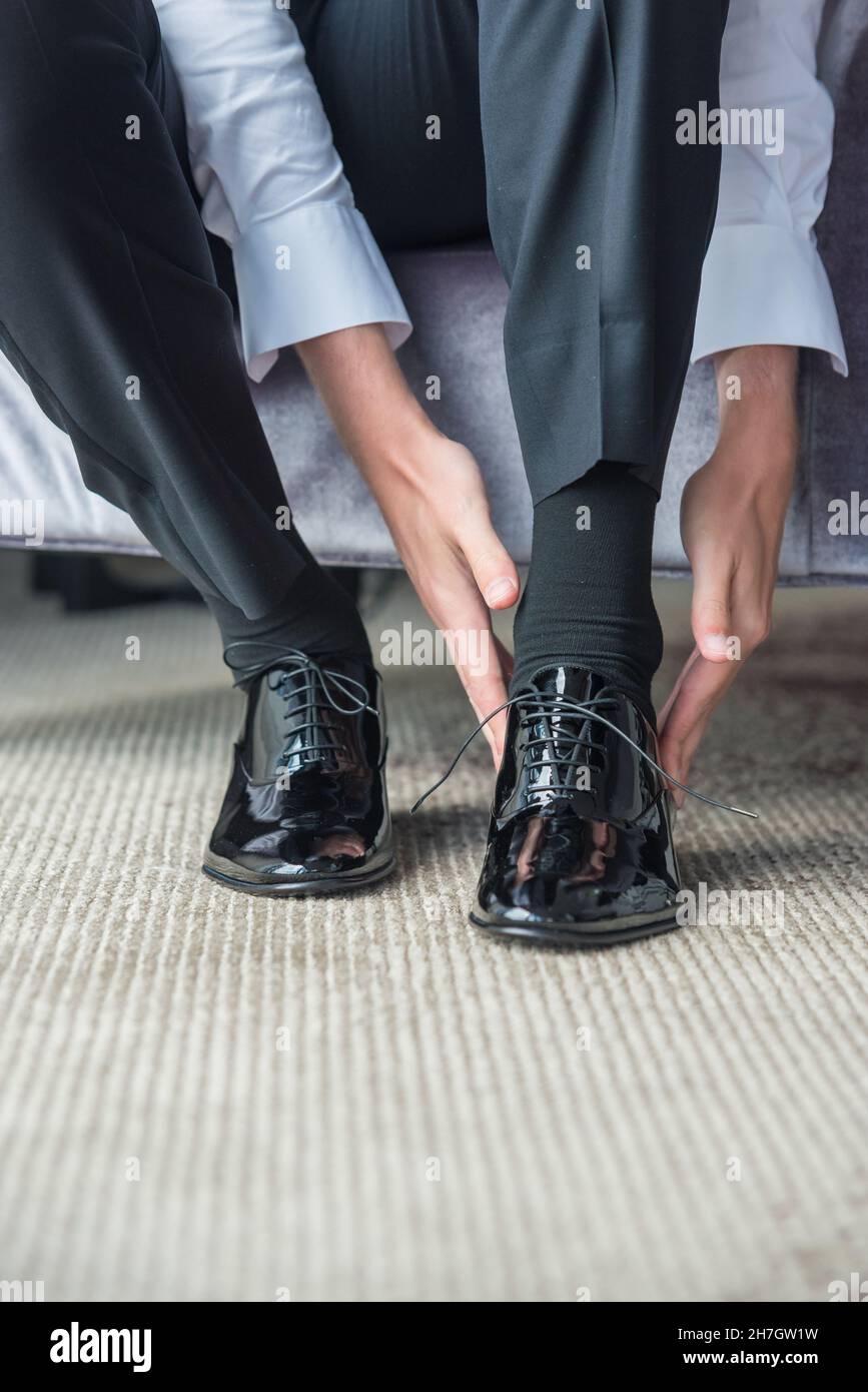 Groom wearing his shoes and getting ready for his wedding Stock Photo ...