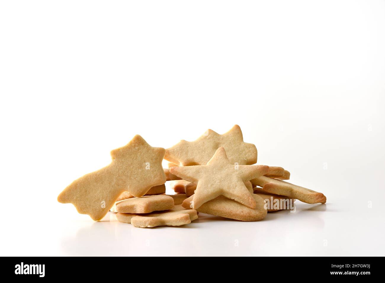 Assortment of Christmas shaped cookies in a pile on white table ...