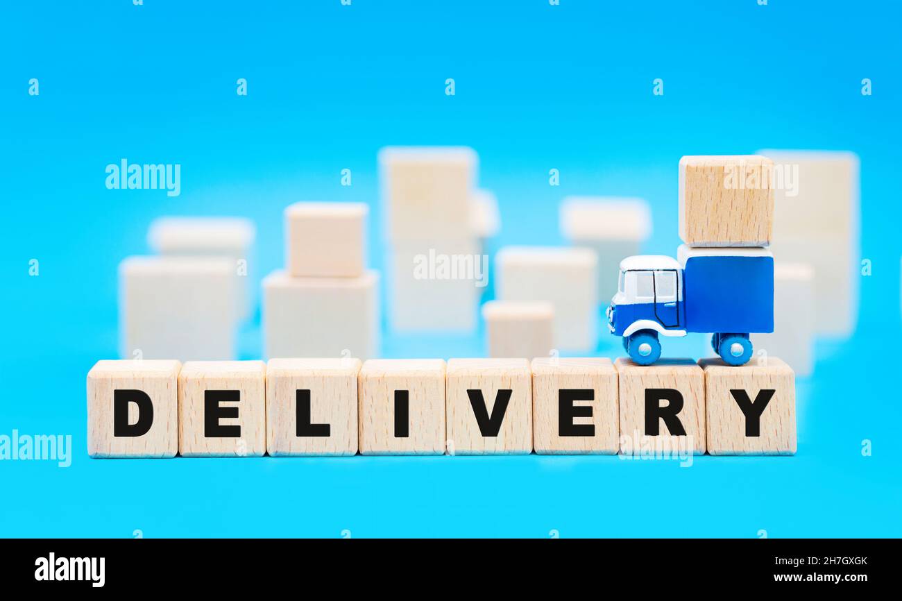 Miniature truck standing on top of a line of letter blocks reading ...