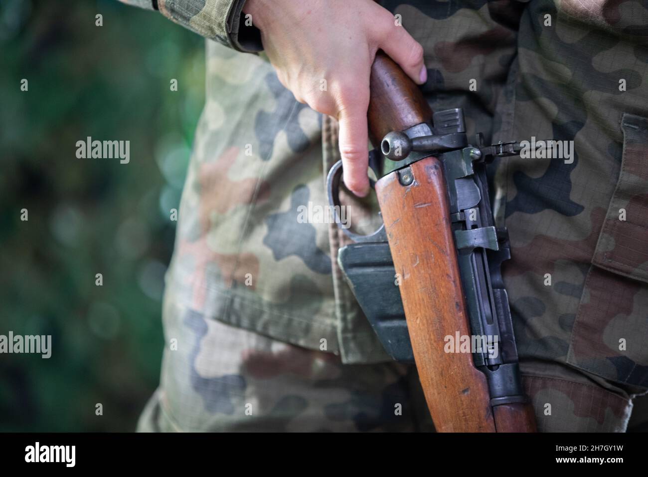 A lady soldier inspects a newly received self-reloading rifle. A close ...