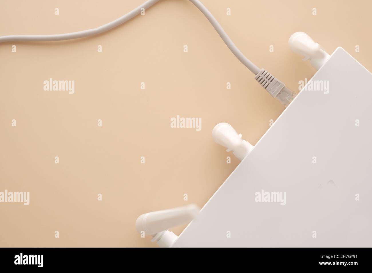 Wi-Fi router with cables on table Stock Photo - Alamy