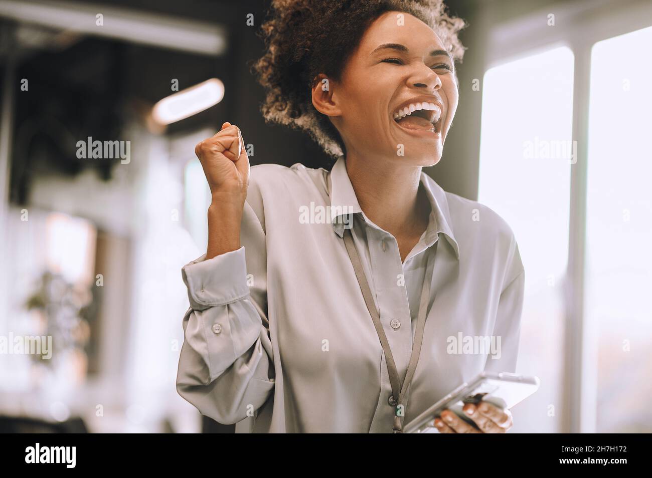 Pretty young woman looking excited and happy Stock Photo - Alamy