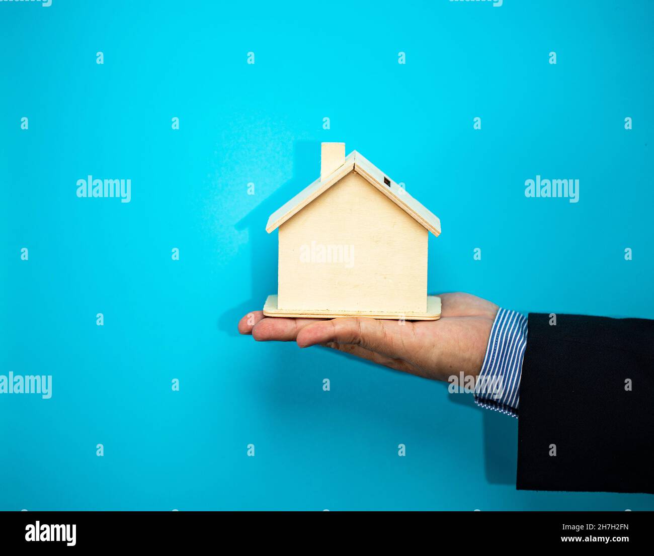 The wooden house place on hands it meaning to hold and take care it and ...