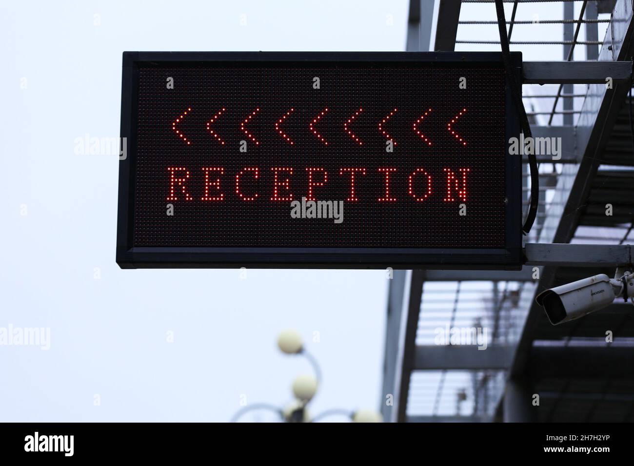 Closeup of a reception direction sign with led lights on a wall ...