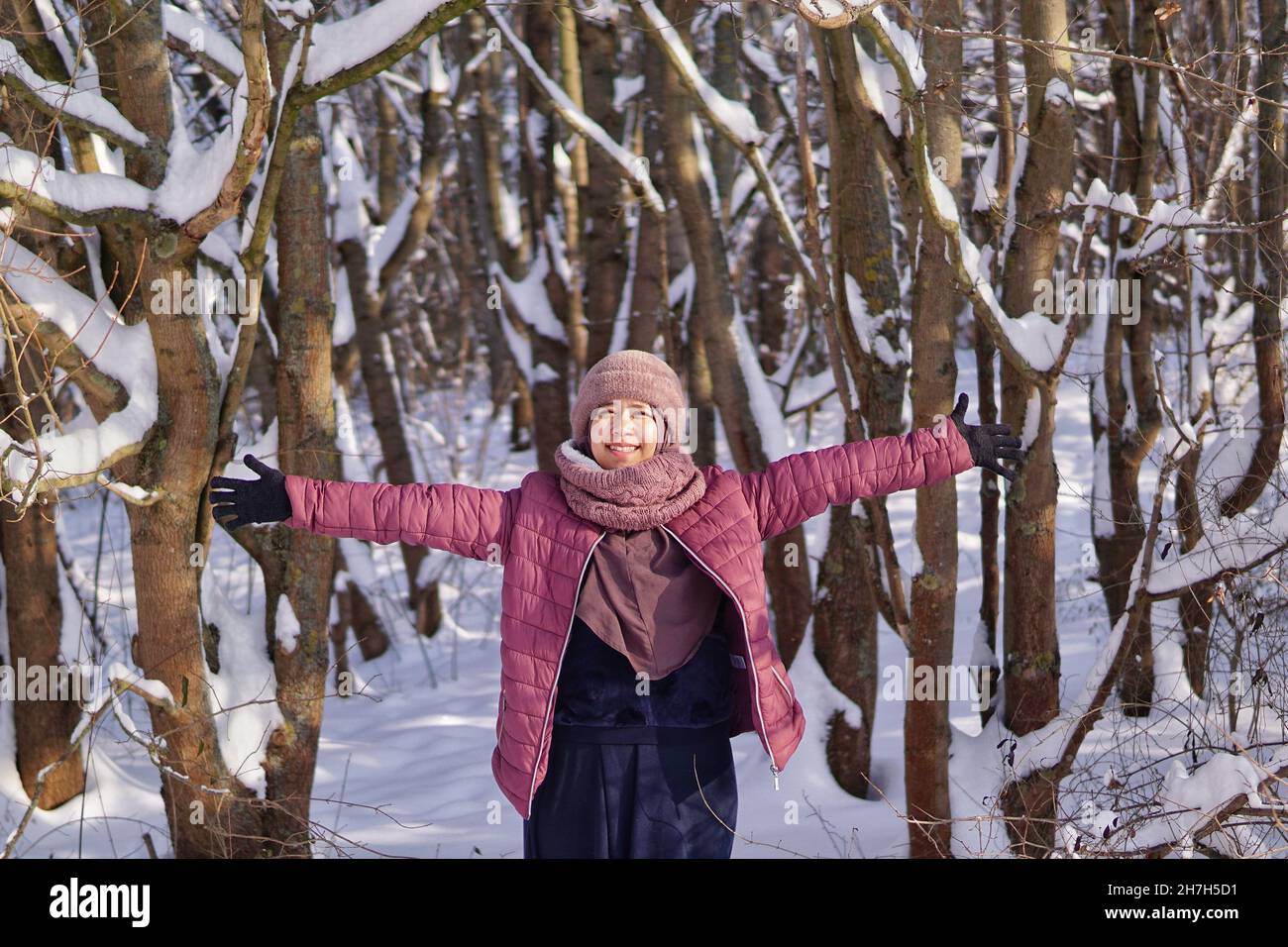 Young Southeast Asian Muslim girl posing in the park during winter ...