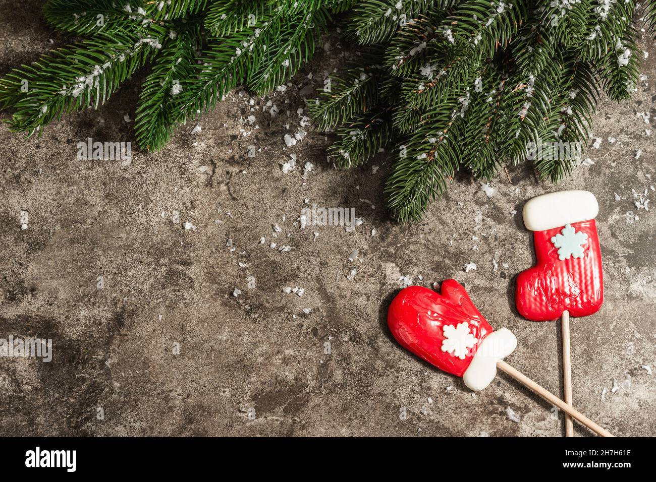 Merry Christmas wreath made of fir branches and lollipops on stone ...