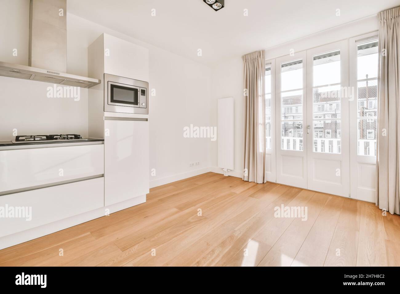 Lovely kitchen with white walls and kitchen set Stock Photo - Alamy