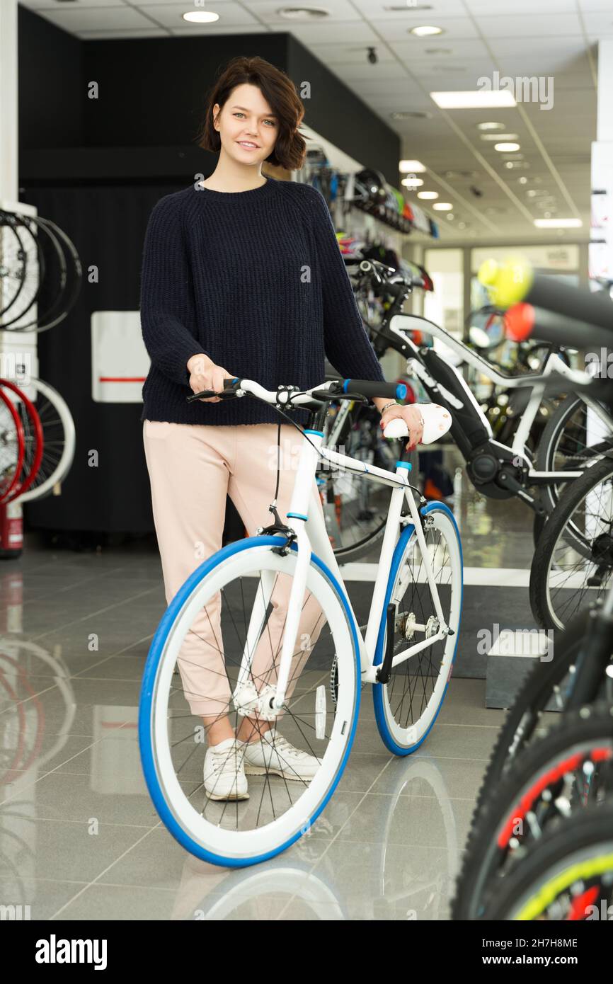 female standing with bicycle Stock Photo - Alamy