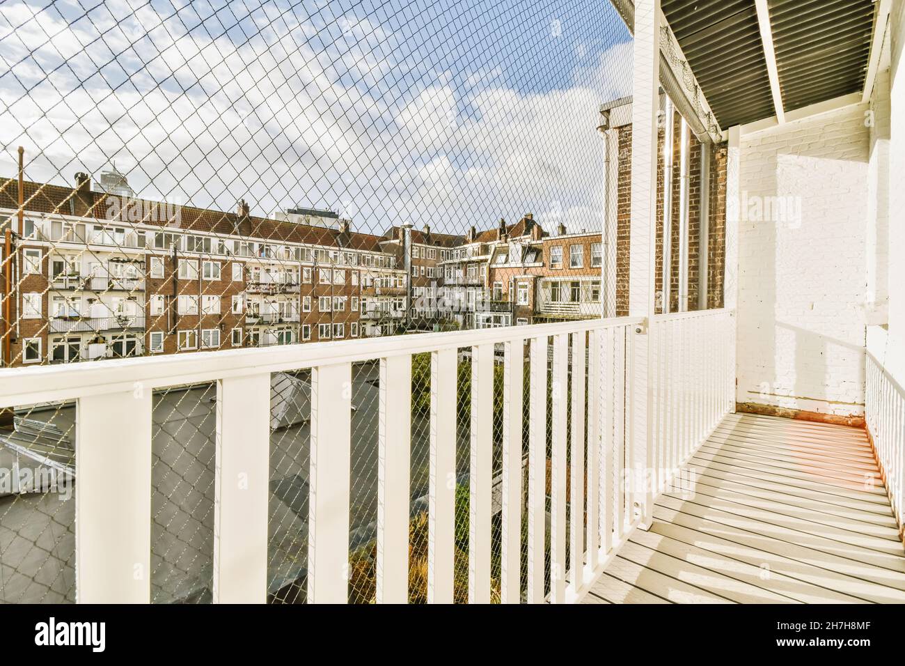 Long narrow balcony with white wooden railings Stock Photo - Alamy