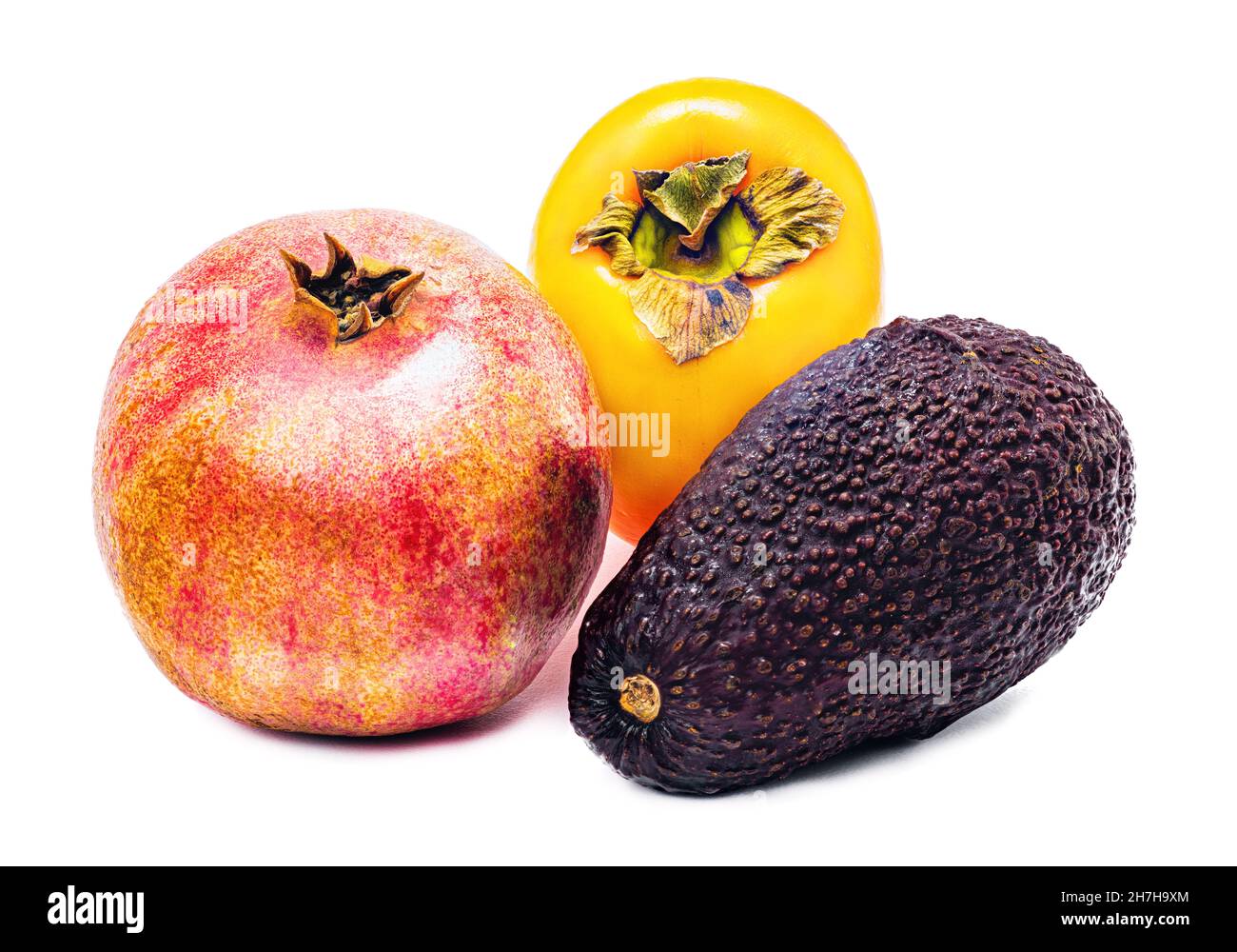 composition of three fruits avocado, pomegranate, persimmon isolated on ...