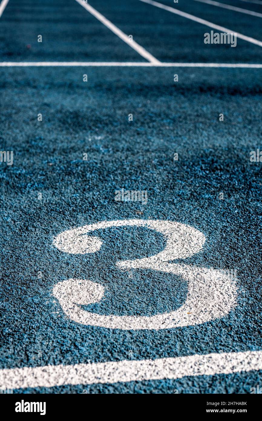 Lane three on the track field Stock Photo - Alamy