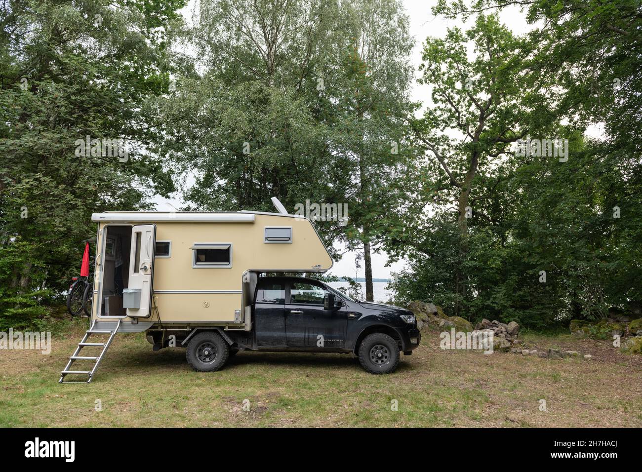 Ford Ranger and add-on cabin directly on the lake in a clearing near ...