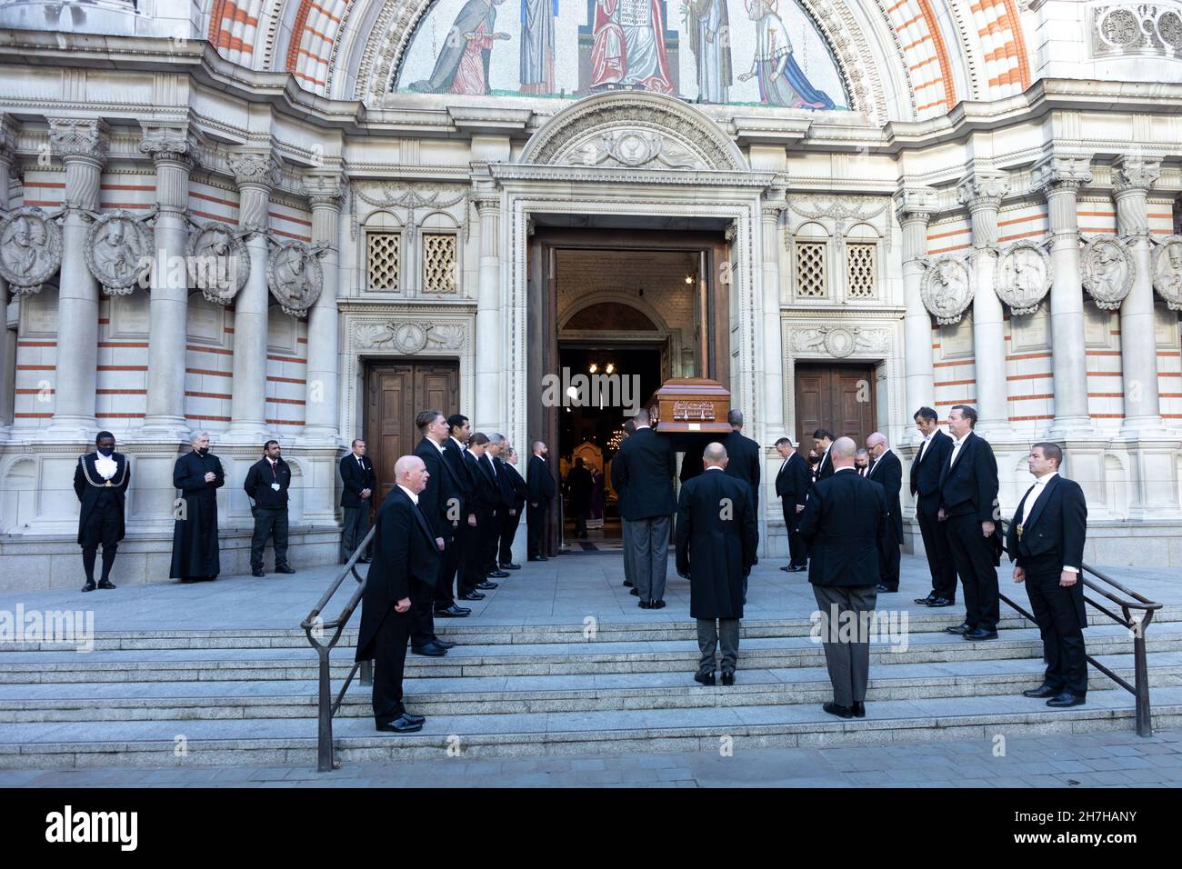 London, UK. 23rd Nov, 2021. Pallbearers seen carrying the coffin up the ...