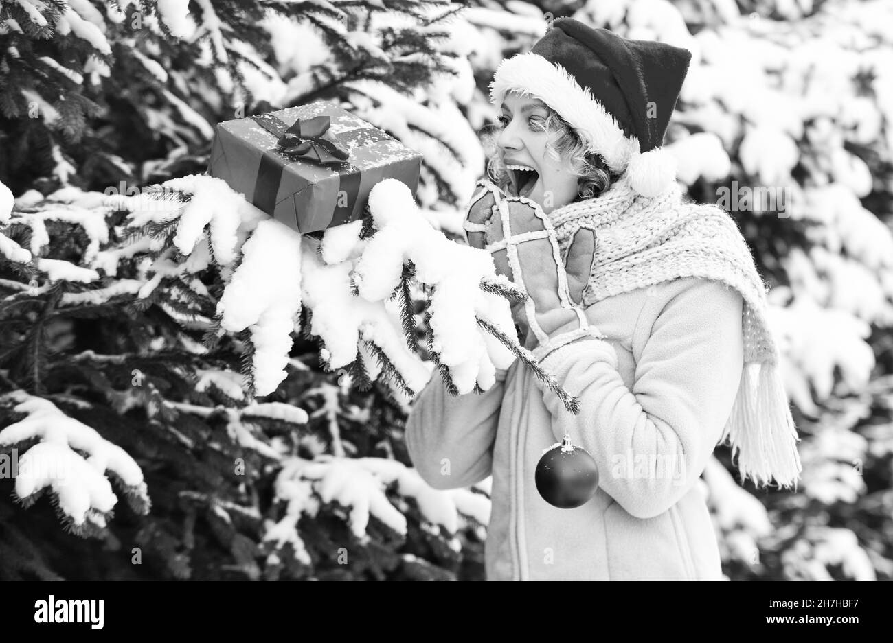 what a surprise. bright weather is prefect mood. happy woman hold xmas ...