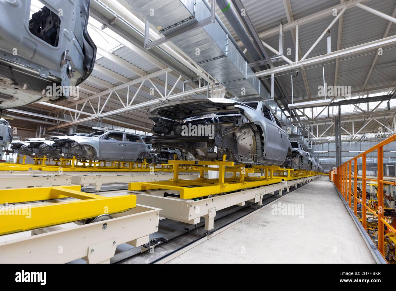 Car bodies are on assembly line. Factory for production of cars. Modern ...