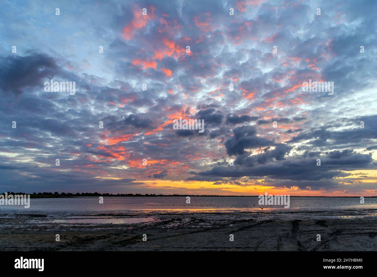 Nice landscape with sunset on lake, fire in sky Stock Photo - Alamy