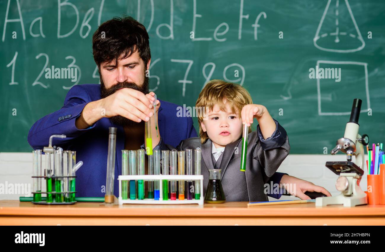 More Intelligence Solutions. man with little boy. Chemistry beaker ...