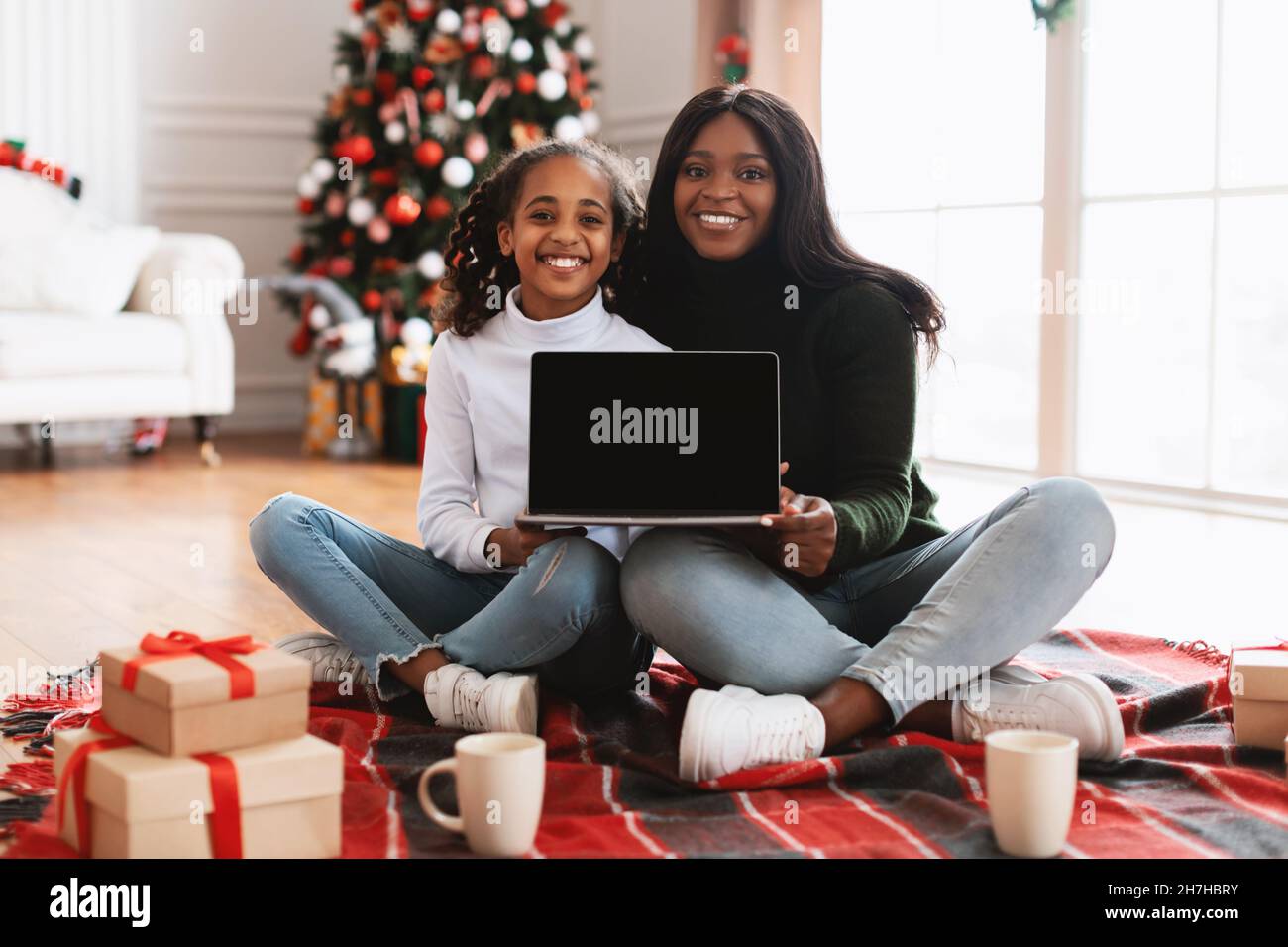 Happy black family showing pc with empty screen, mockup Stock Photo - Alamy