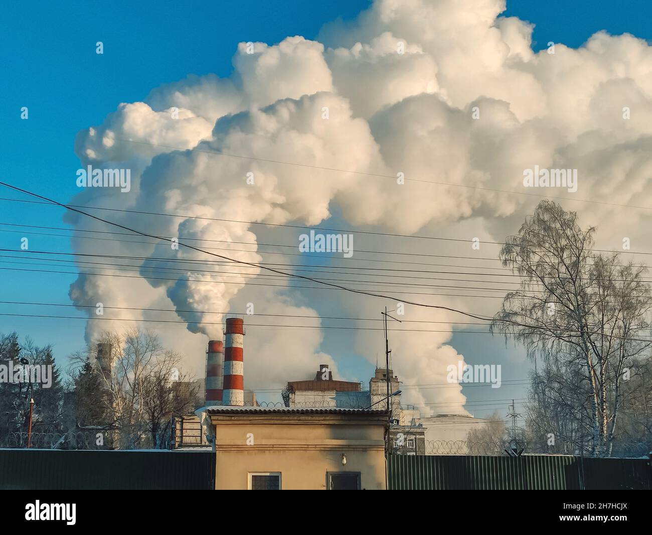 Huge clouds of smoke from chimneys, pipes of a thermal power plant ...