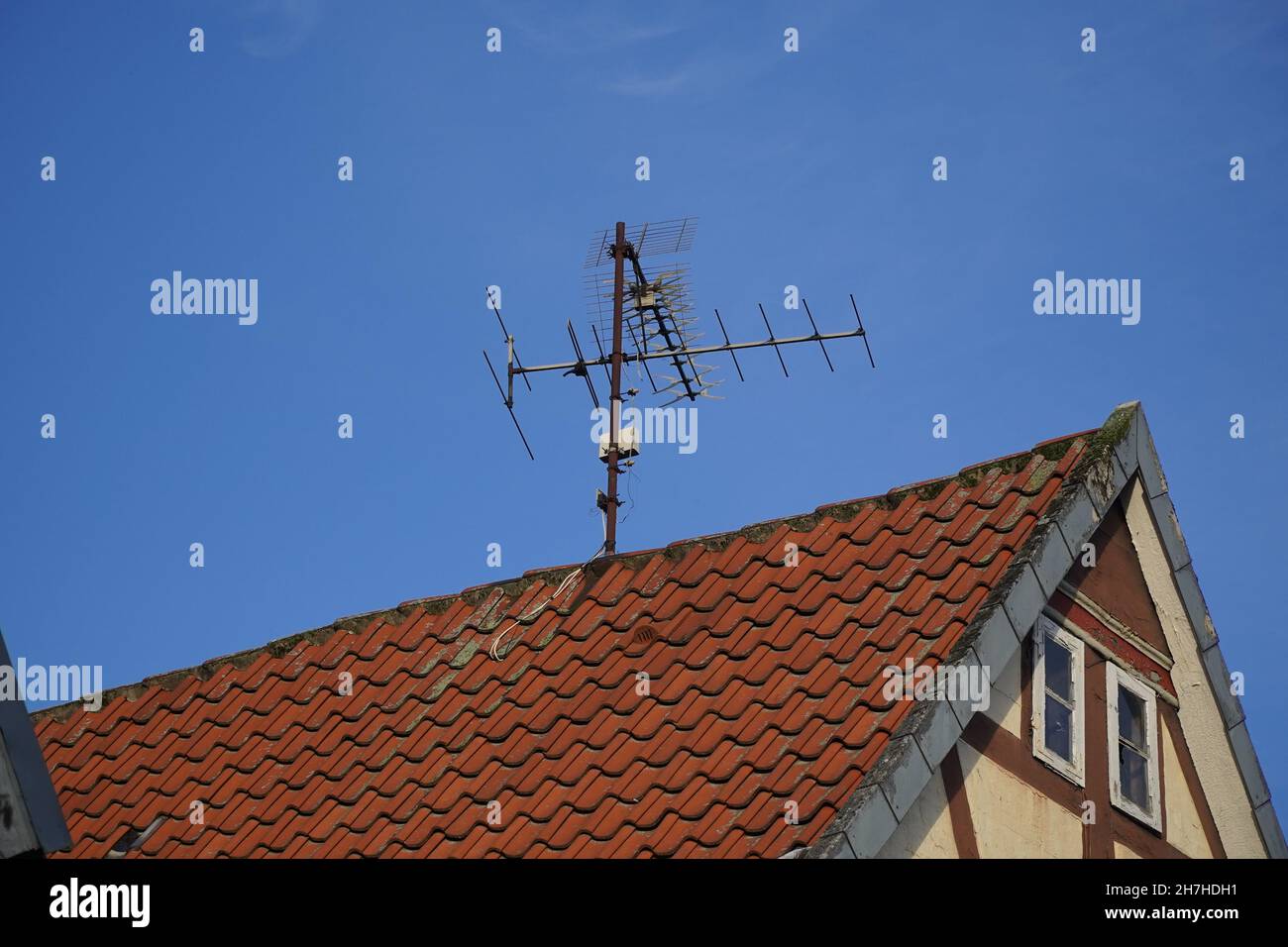 Roof of old house with old analog tv antenna, old technology for TV ...