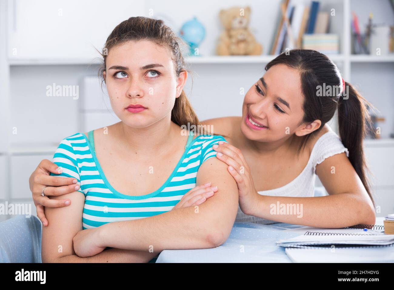 Girl trying to apologize to friend Stock Photo - Alamy