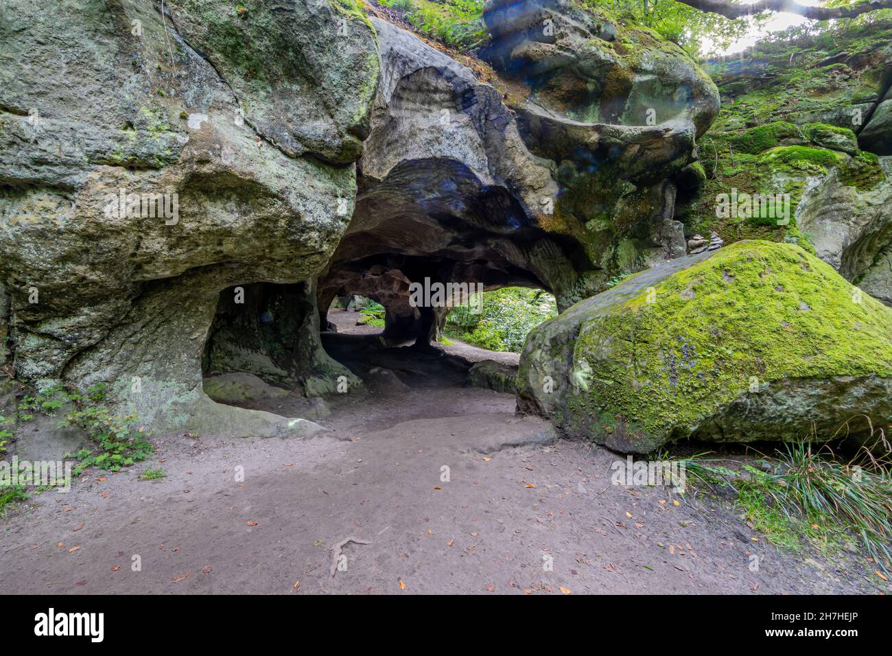 Huge rock with moss at the entrance of the rock formation Huel Lee or ...