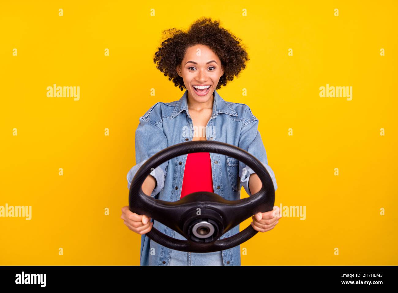 Photo of young cheerful happy afro american woman hold hands steering ...