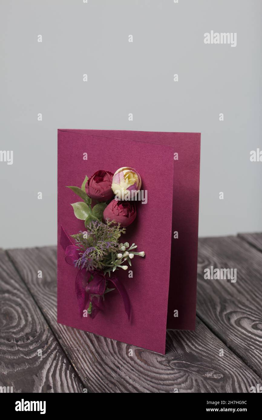 Homemade greeting card. Made of paper and decorative flowers. On black ...