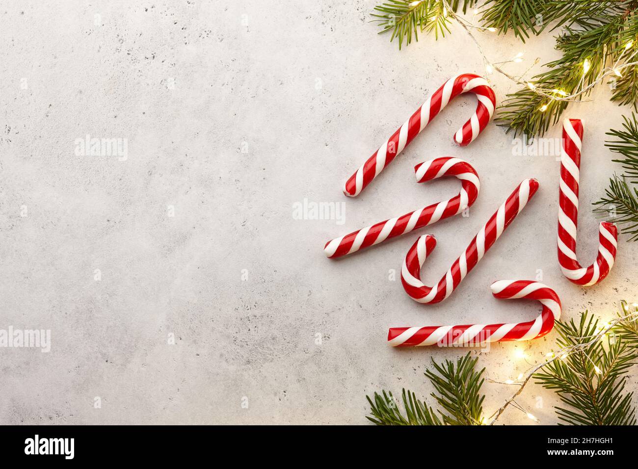 Sweet candy canes with fur tree decorations and christmas lights Stock ...
