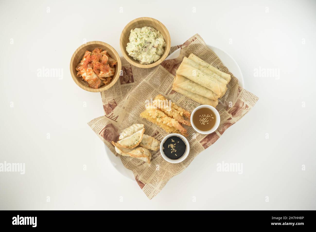 Closeup shot of fried spring rolls, tempura, and dim sum isolated on a ...