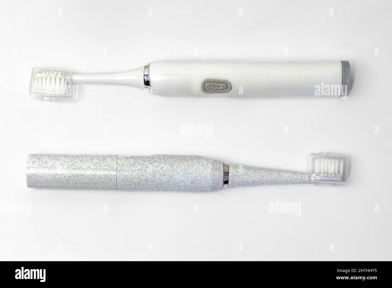 two white electric toothbrushes that run on battery and vibration Stock ...