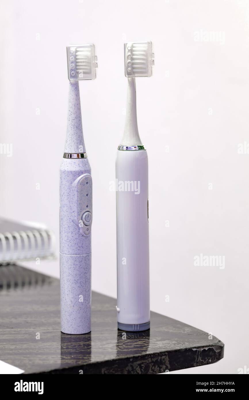 two white electric toothbrushes that run on battery and vibration Stock ...