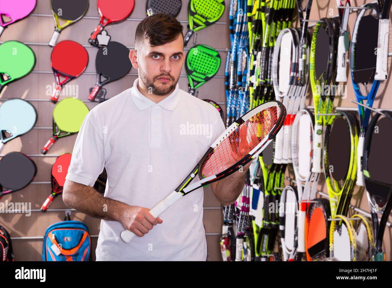 Man looking at tennis equipment hi-res stock photography and images - Alamy