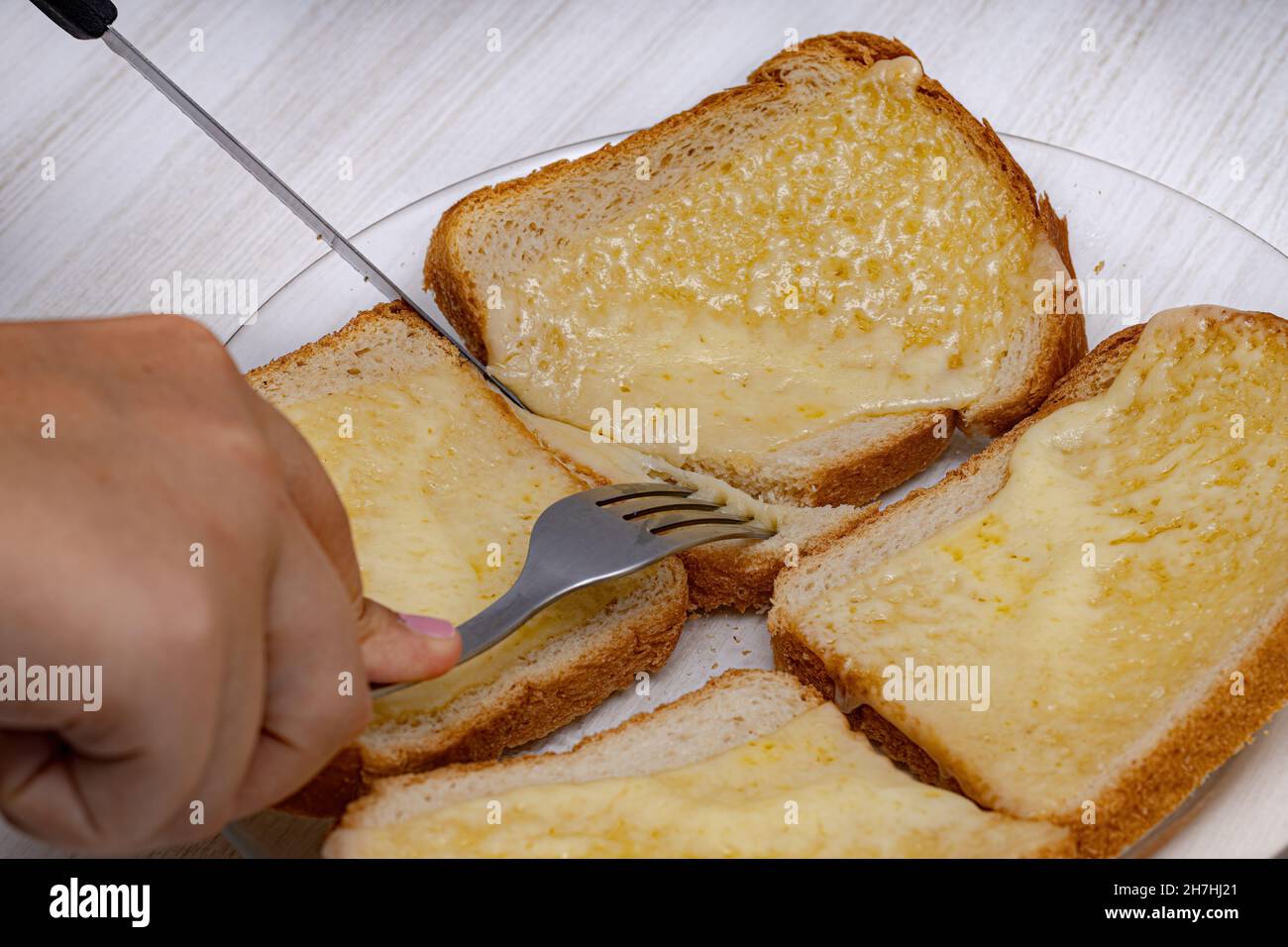 Loaf of bread with slice of melted mozzarella cheese on top Stock Photo ...