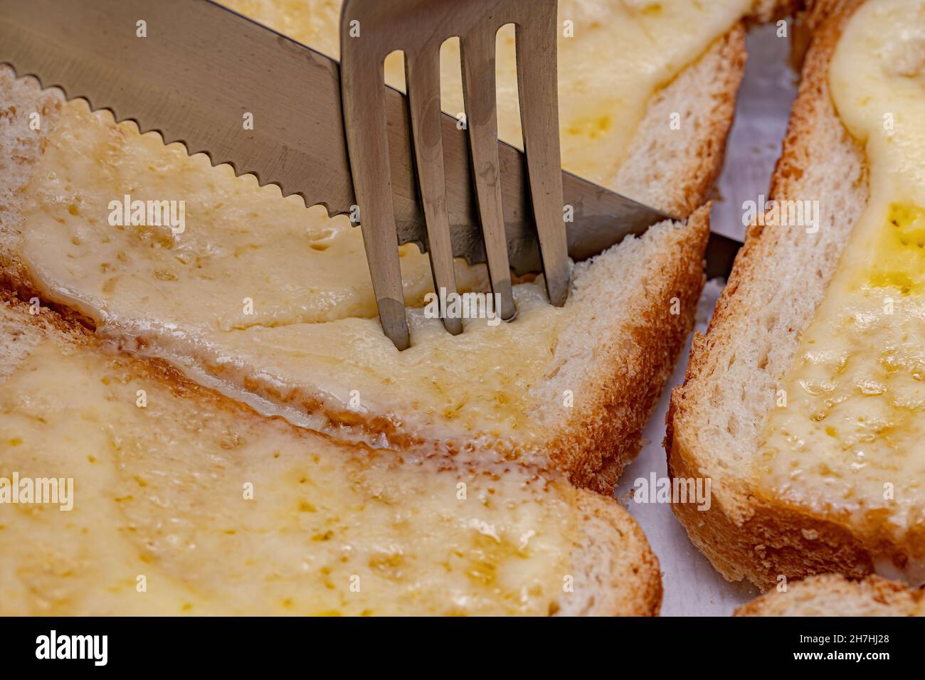 Loaf of bread with slice of melted mozzarella cheese on top Stock Photo ...