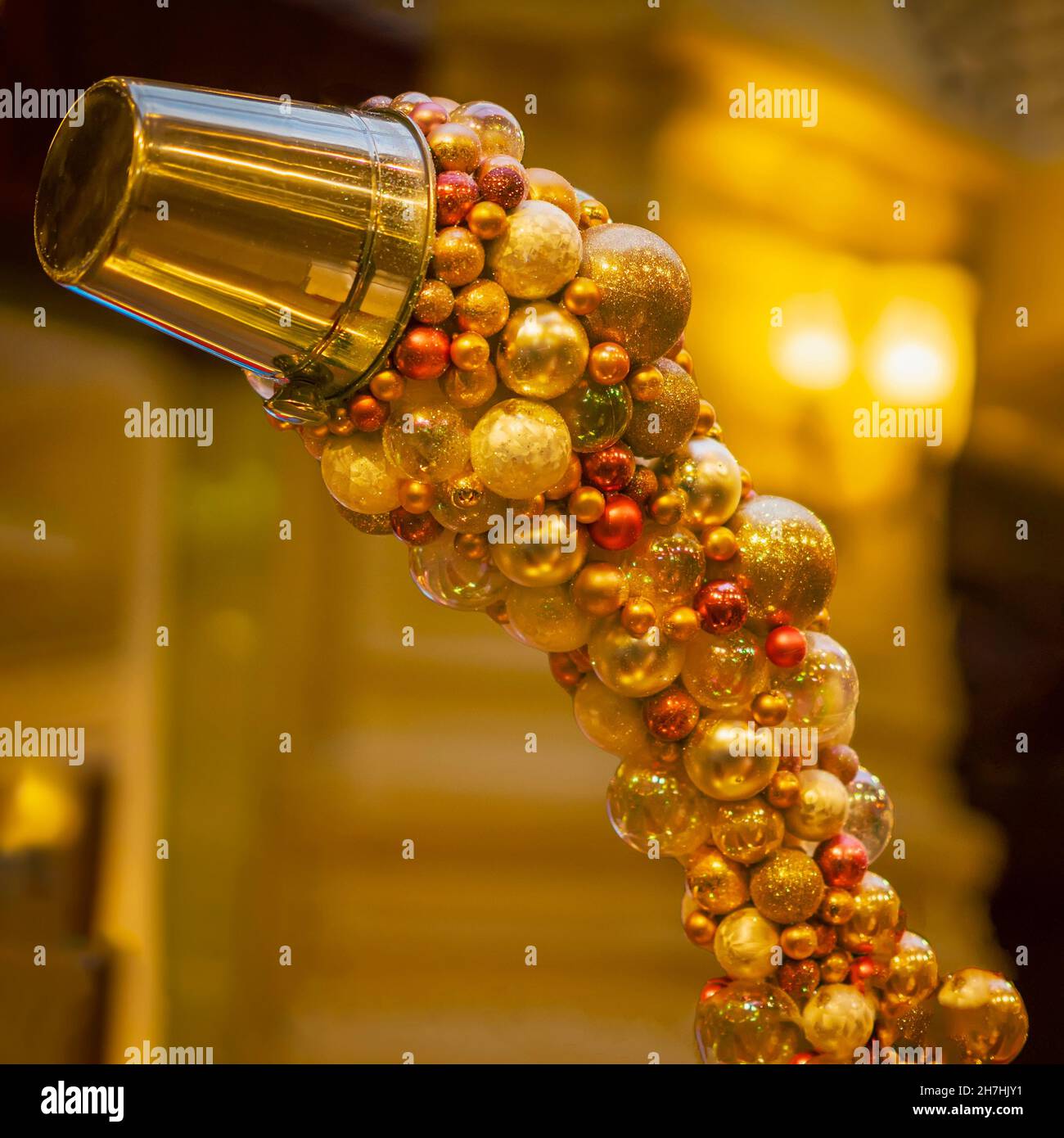 Magic bucket with falling from top to bottom Christmas balls on golden ...