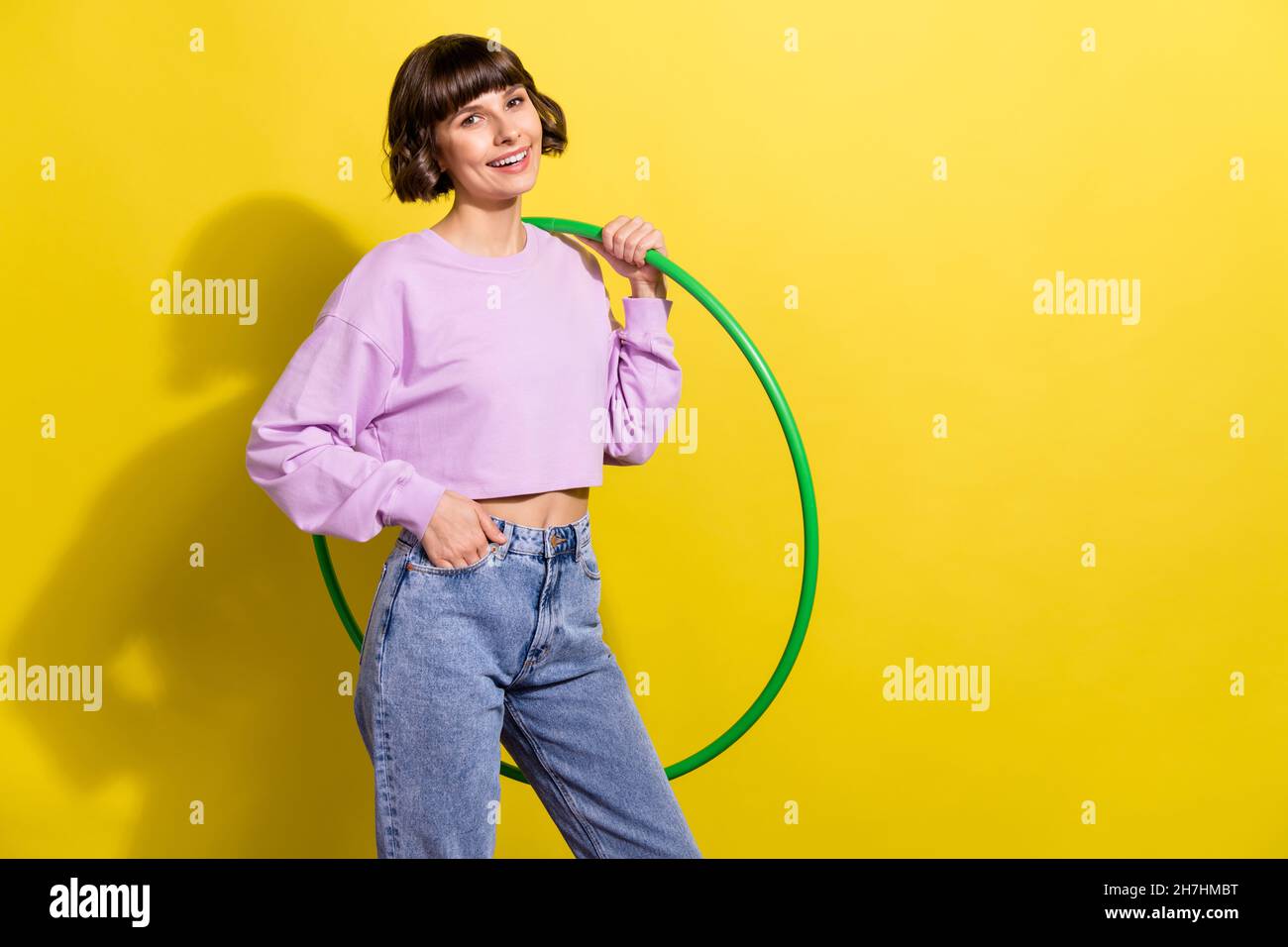 Portrait of attractive cheerful girl holding hula hoop copy empty space ...