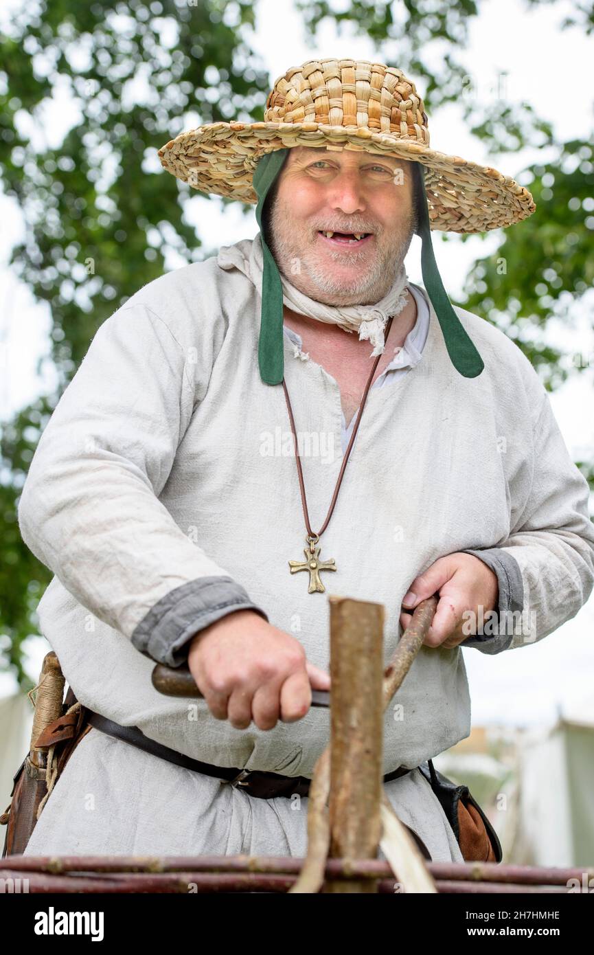 A medieval hurdle maker demonstrates his craft before a display of The ...