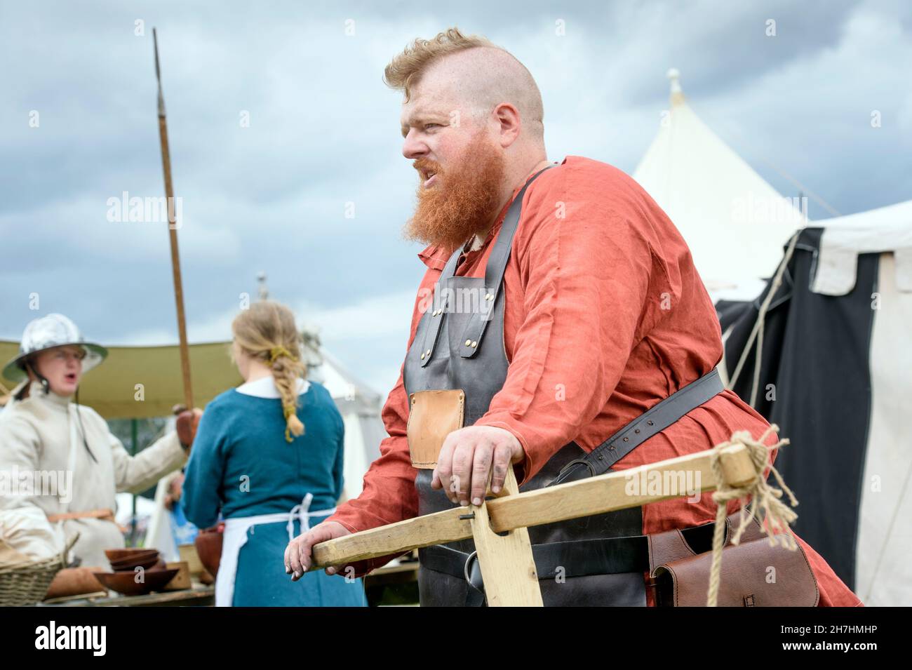 A medieval blacksmith demonstrates his craft before a display of The ...