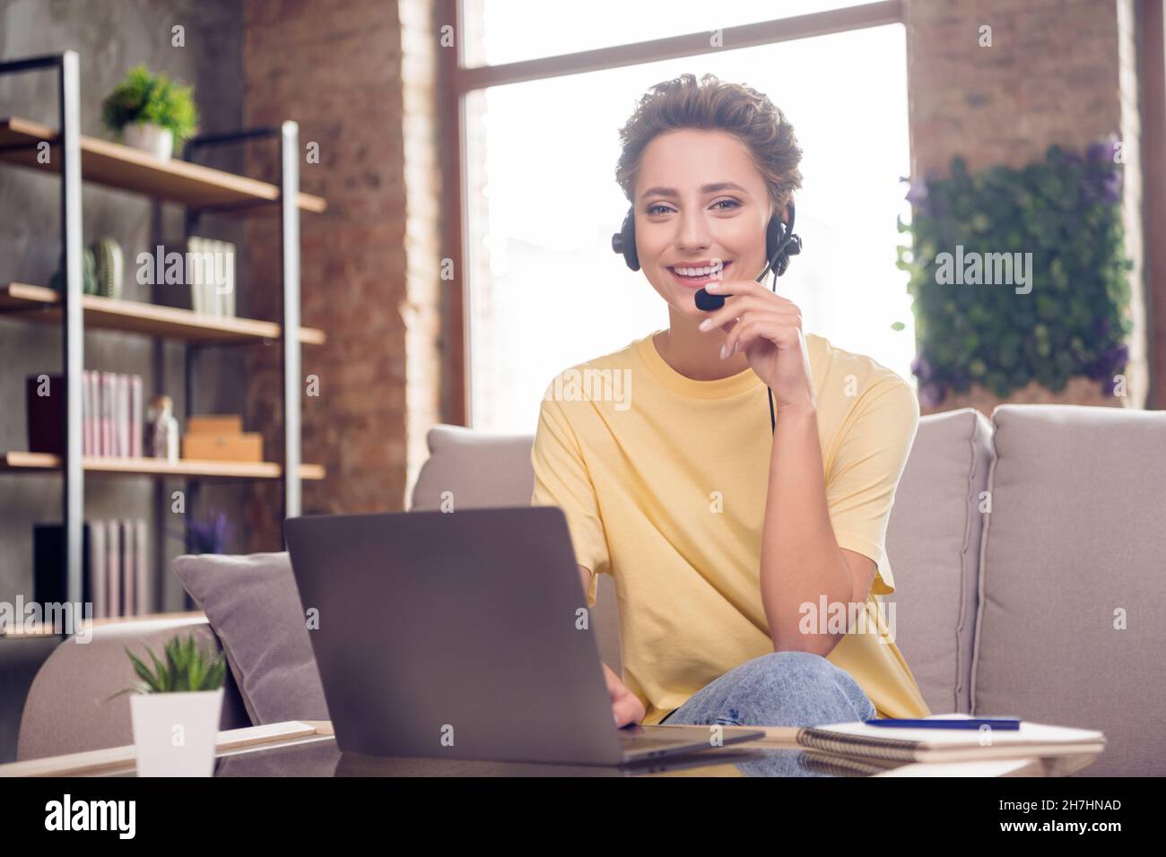 Photo of pretty reliable operator lady hold laptop work wear headset ...