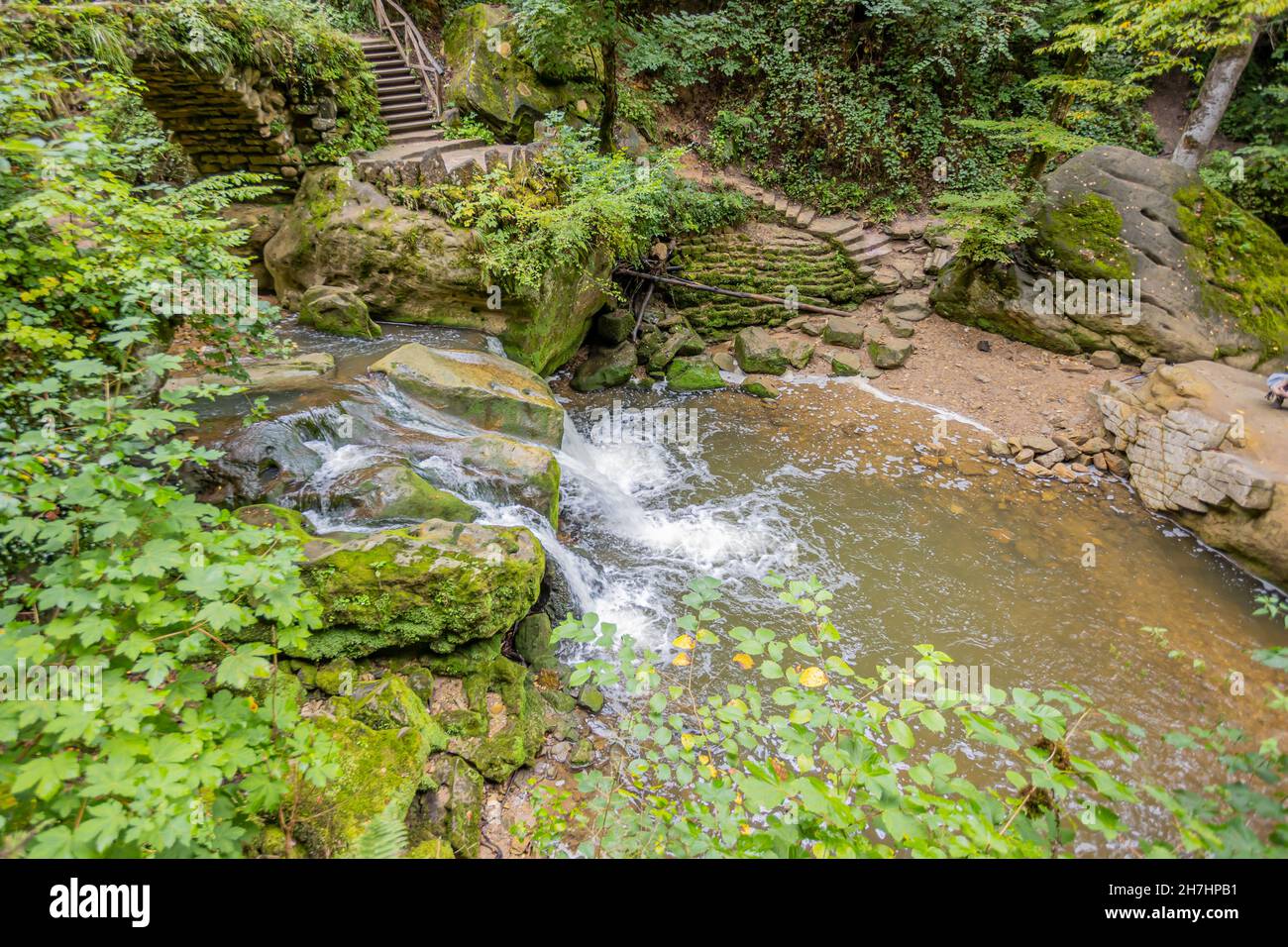 Black Ernz river and the Schiessentümpel waterfall seen from a higher ...