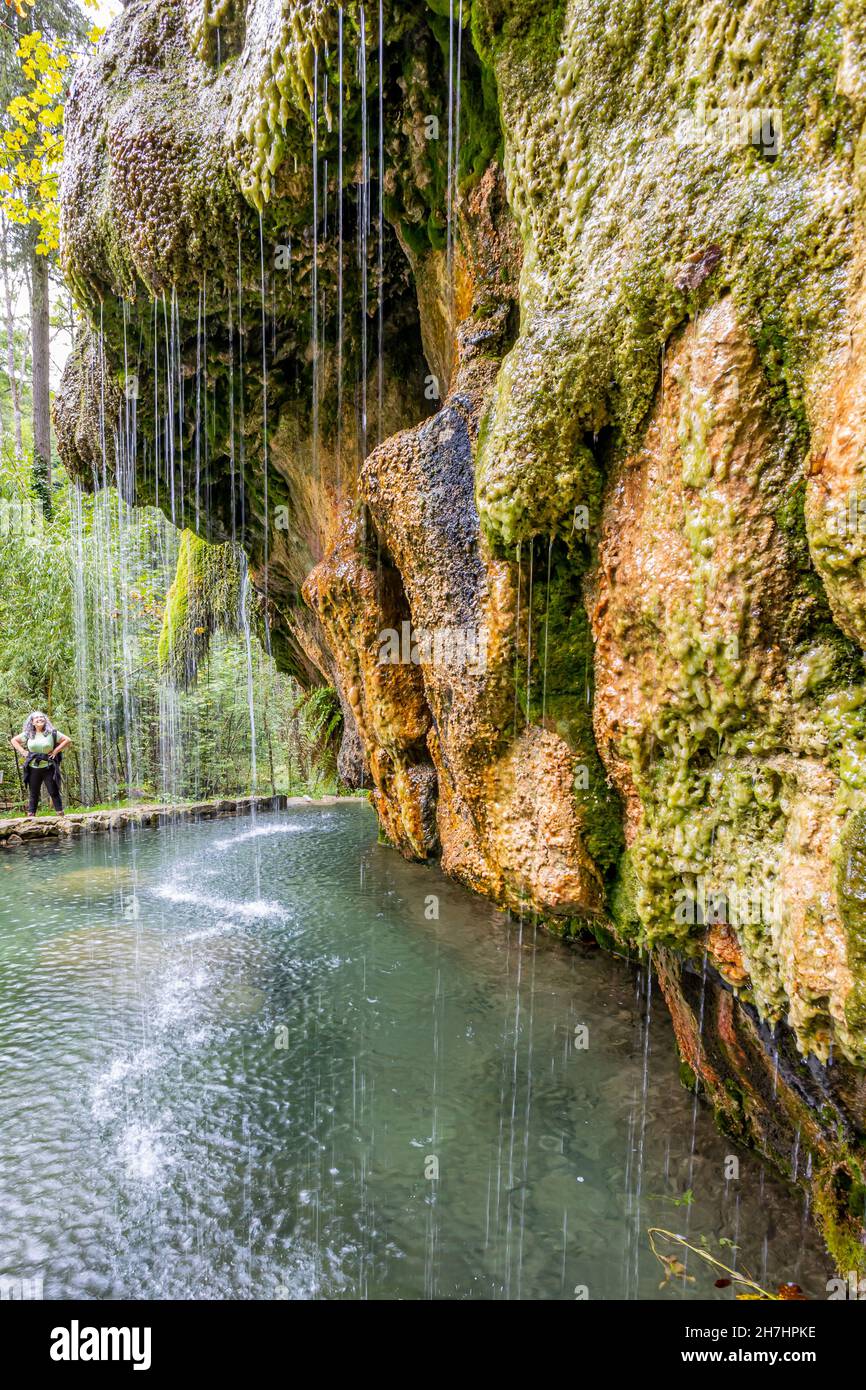 Moss covered rock formation with calcareous crystal clear water falling ...