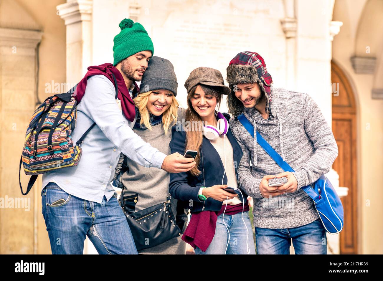 Group of young hipster tourists friends having fun with smartphone in ...