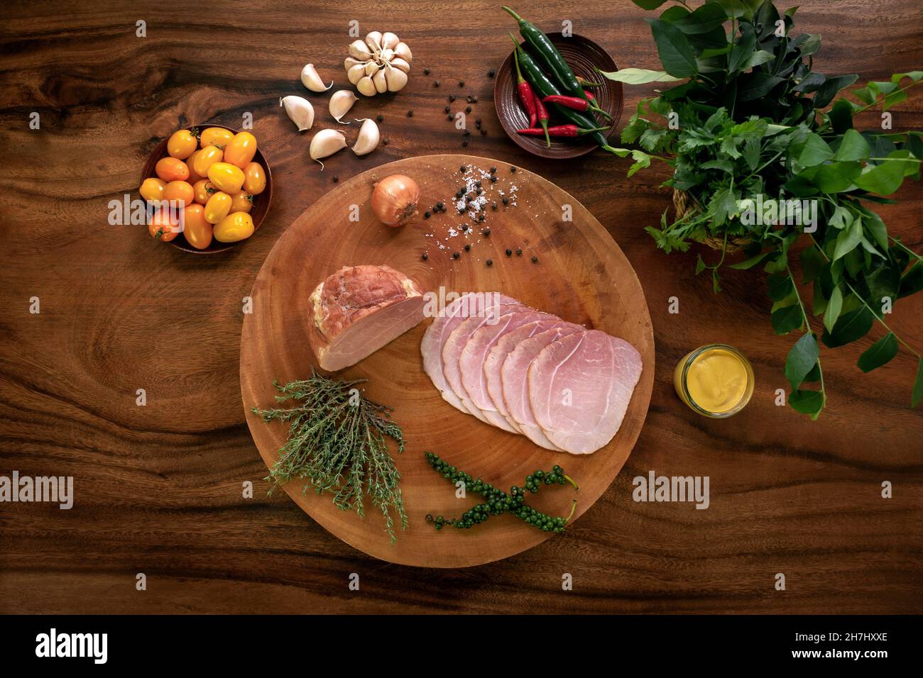 smoked ham on rustic wood table with natural ingredients arrangement ...
